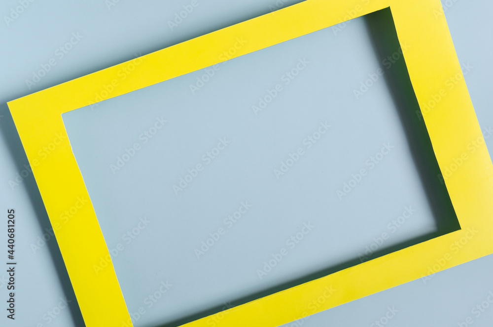 Yellow paper frame with shadows, on a white background. The flat ley ...