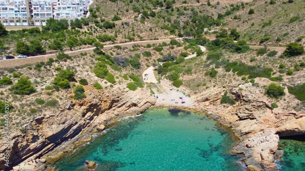 Tourist At Cala Tio Ximo With Rustic Terrain And Calm Blue Sea In ...