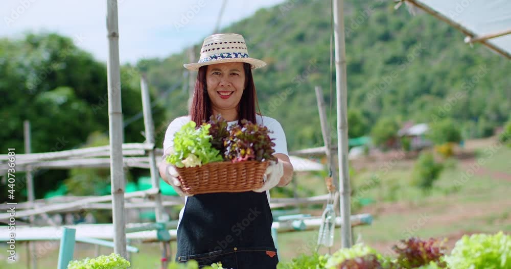 Asian female farmer with long hair wearing a hat, white t-shirt, white ...