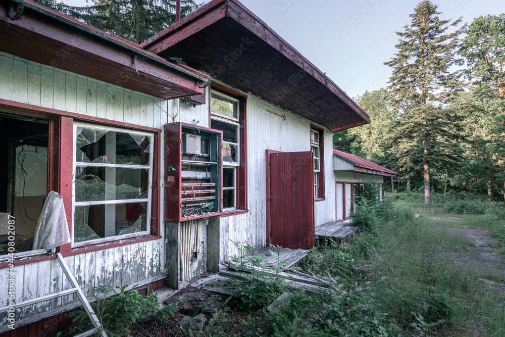 Old abandoned wooden house falling apart. Broken windows, scattered ...