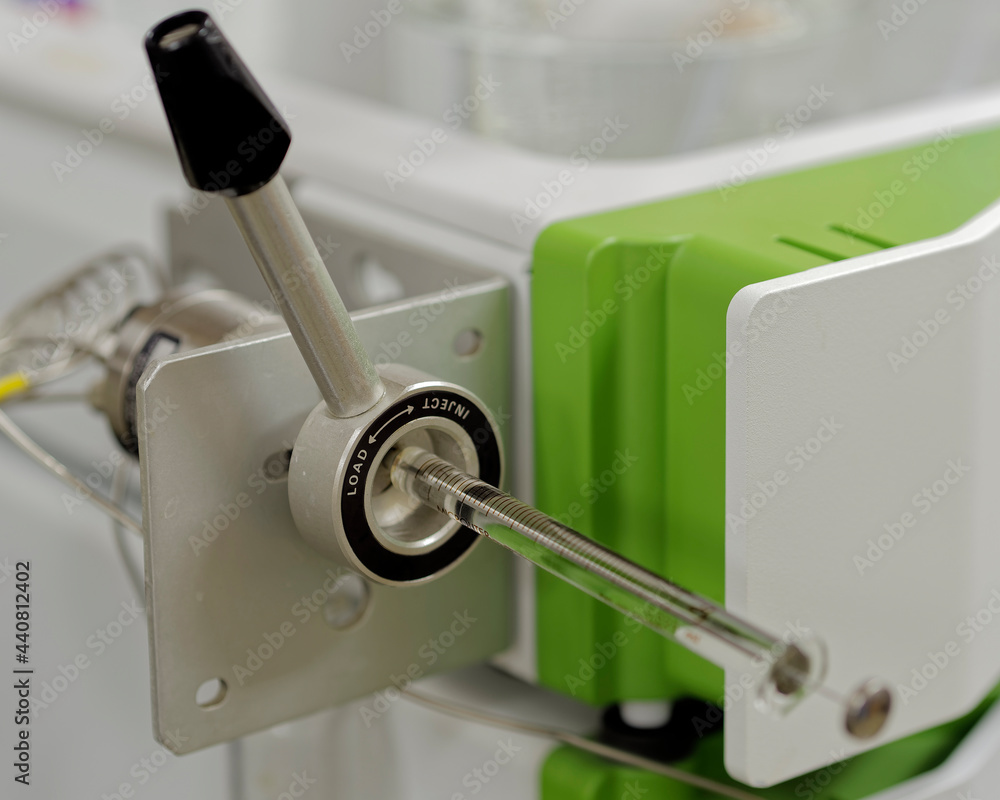 A syringe loaded into a sample injector of a high performance liquid ...