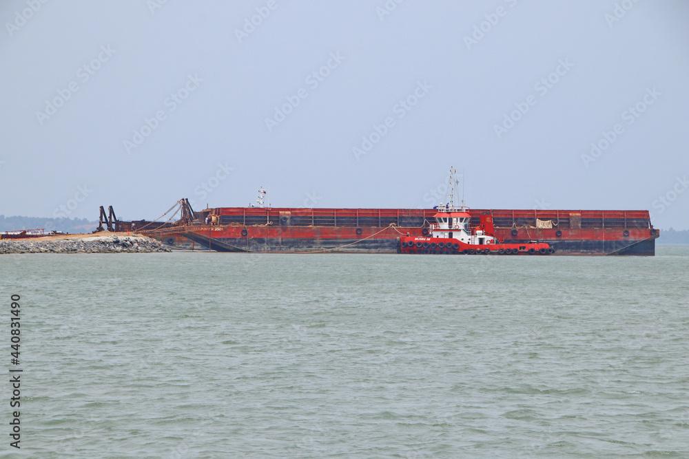 BATAM, INDONESIA - Aug 06, 2019: Large Cargo Barge is on the beach ...