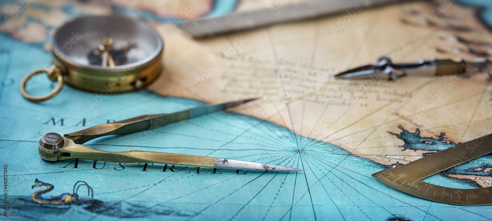 An old geographic map with navigational tools: compass, divider, ruler ...