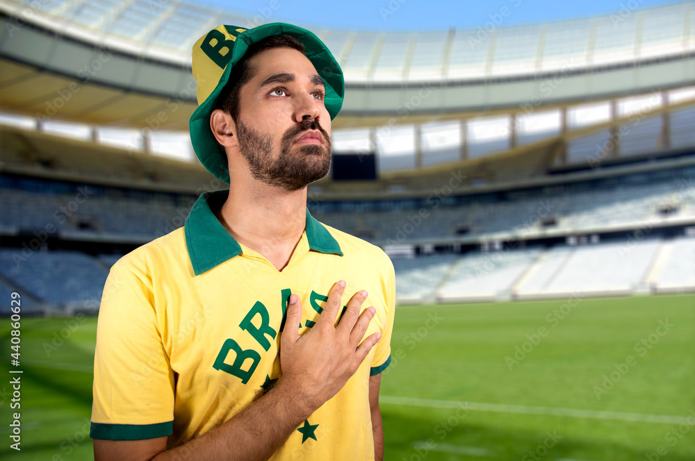 Brazilian sports fan in a position of respect to hear the national ...
