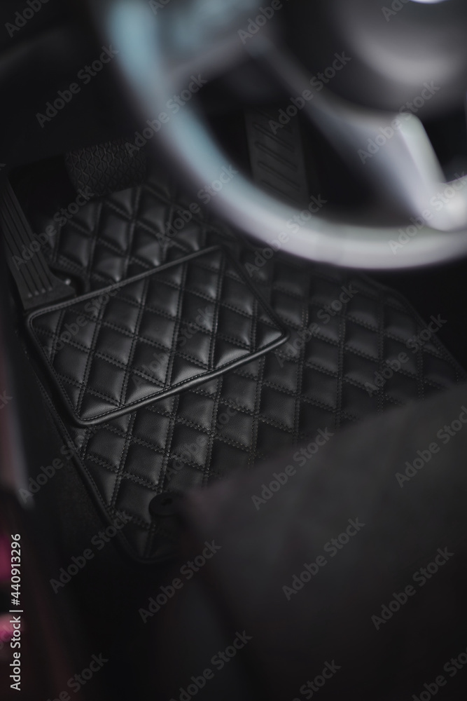 driver seat in the modern luxury car. luxury leather black floor mat ...