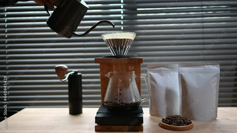 Close up hand drip coffee by spilling hot water through a layer of ...