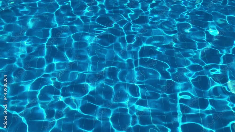 Top view of Pure blue water surface in the pool with light reflections ...