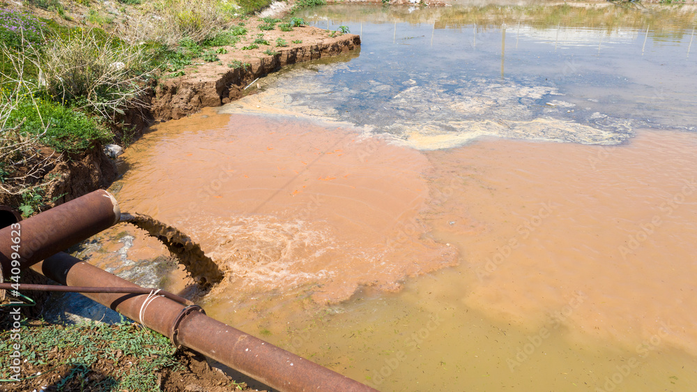 Waste water flows to river. Dirty water and environmental pollution ...