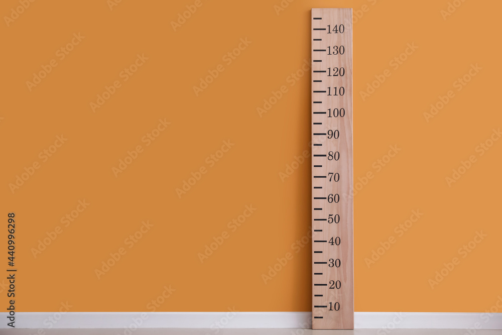 Wooden stadiometer near color wall Stock Photo | Adobe Stock