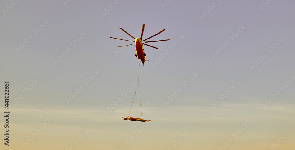 The world's largest cargo helicopter hovers overhead. Bottom view.The ...