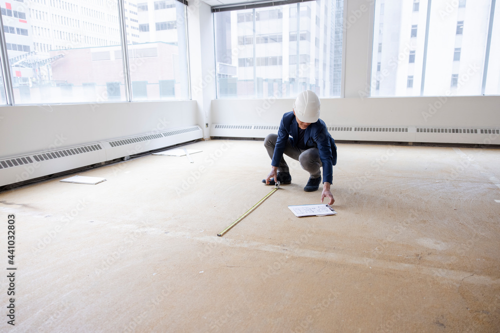 Architect measuring empty office space Stock Photo | Adobe Stock