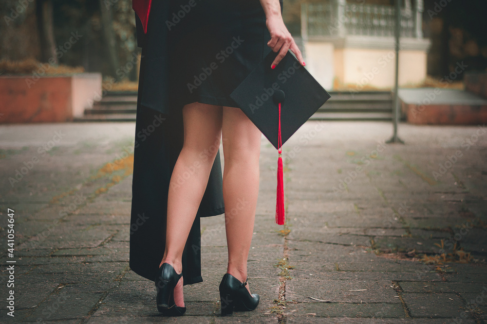 Shot from the back of a graduate, he is walking to attend the ...