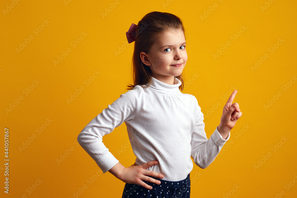 Displeased young girl waving index finger in no and prohibition gesture ...