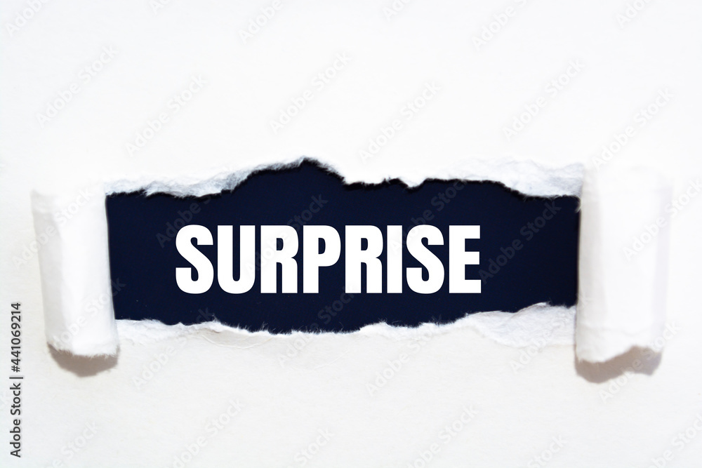 SURPRISE word written under torn paper. Stock Photo | Adobe Stock