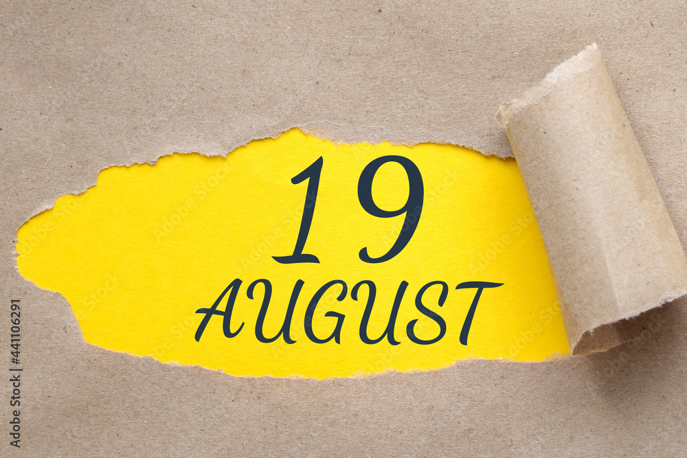 august 19. 19th day of the month, calendar date.Hole in paper with ...