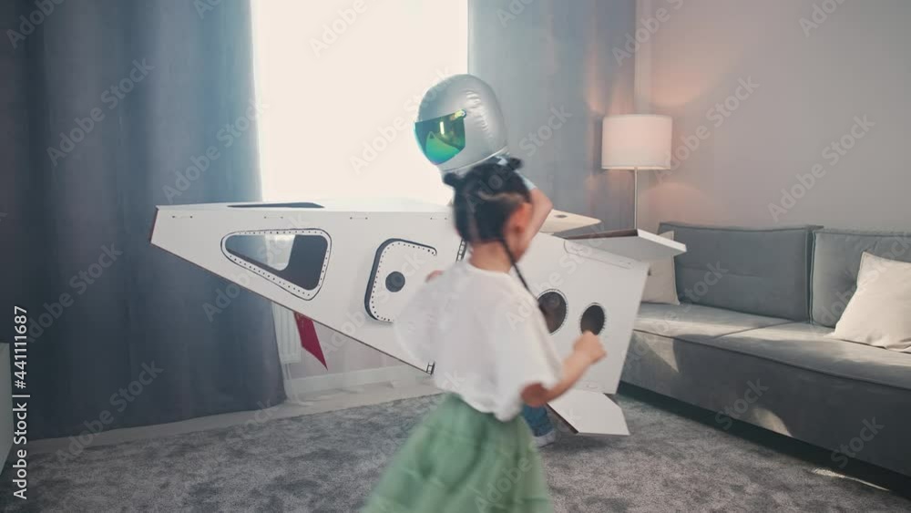 Chinese kids play in the living room of the house, a boy in an ...