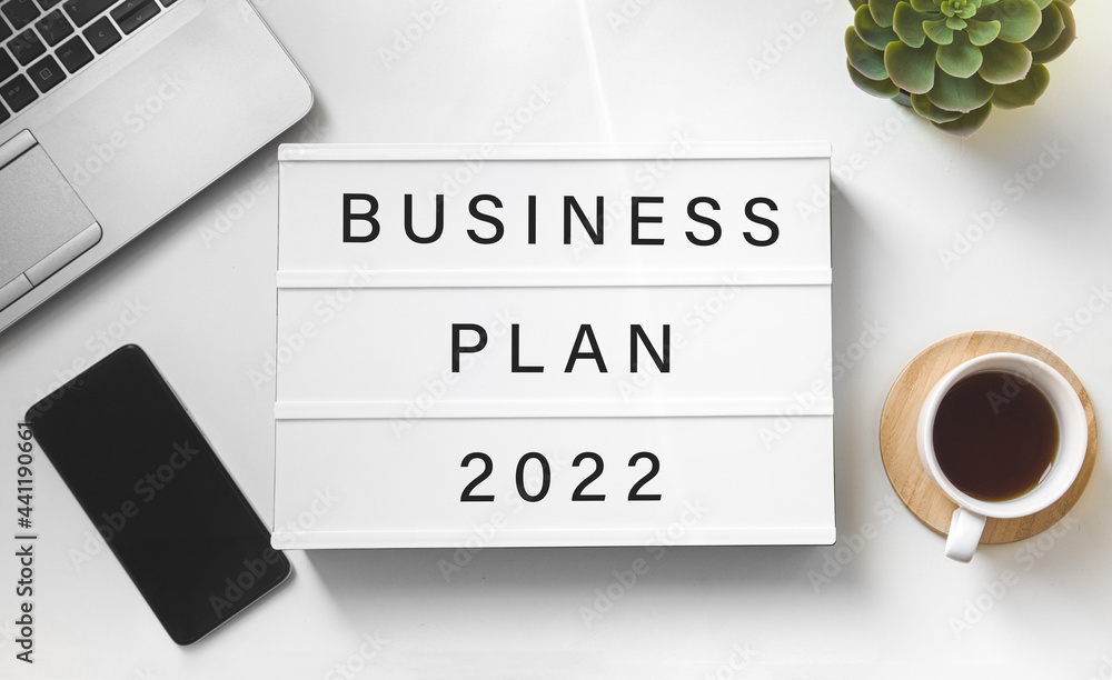 plan for 2022. Calendar and office accessories on the table top view ...