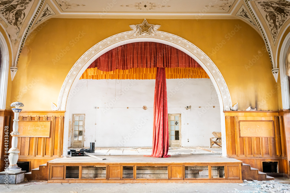Old abandoned sovet hall show stage with red curtains and SSRS star on ...