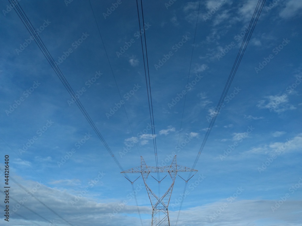 Foto de high voltage power grid on blue sky background do Stock | Adobe ...