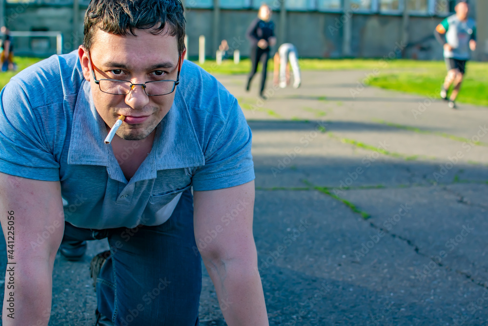 the face of a smirking, self satisfied man with glasses and a cigarette ...