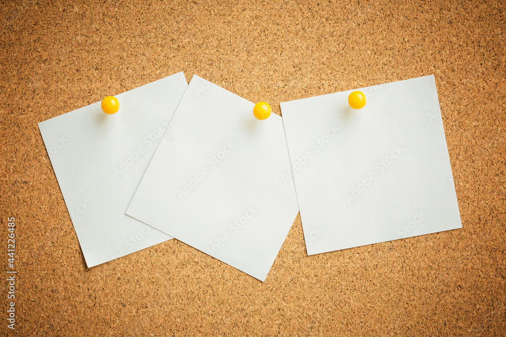 yellow pin white paper on cork board texture or background for note ...