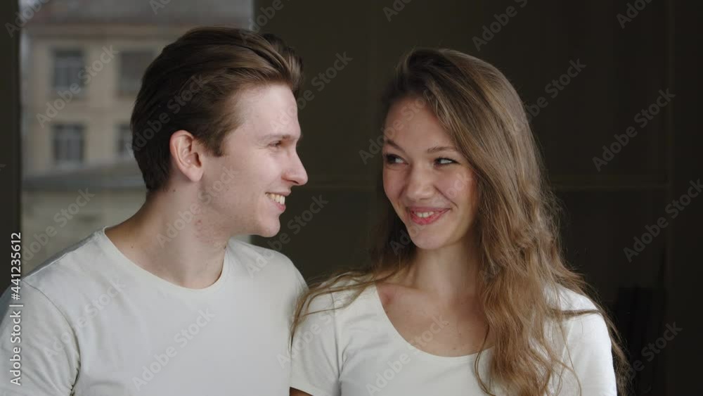 Caucasian young married couple lovers of millennials stand together ...