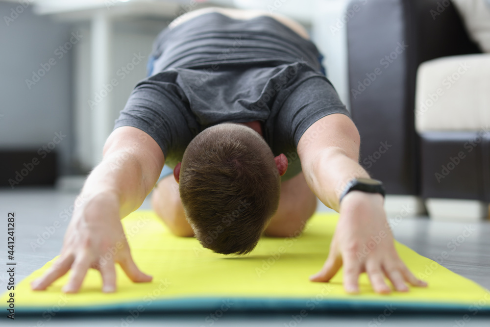 Young man is doing exercises to stretch his back muscles Stock Photo ...
