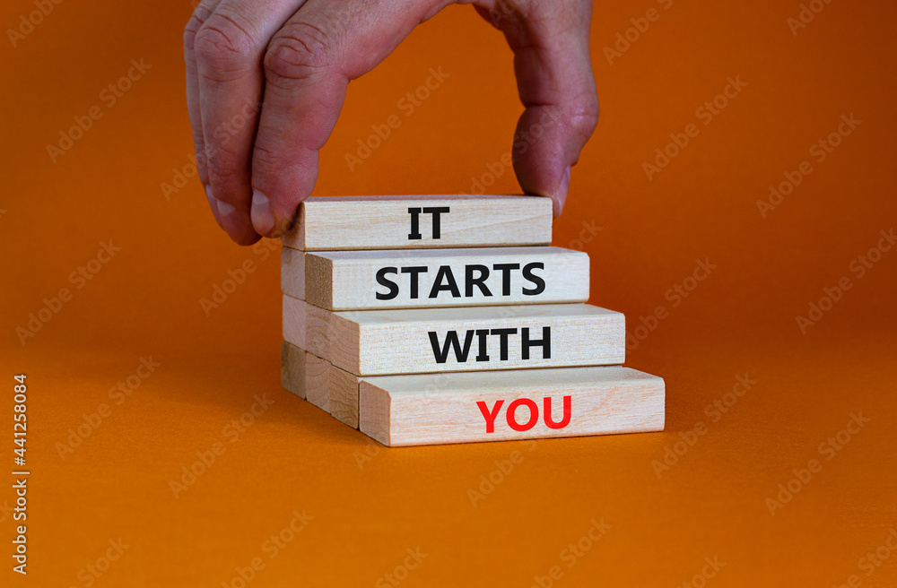 It starts with you symbol. Wooden blocks with words 'it starts with you ...
