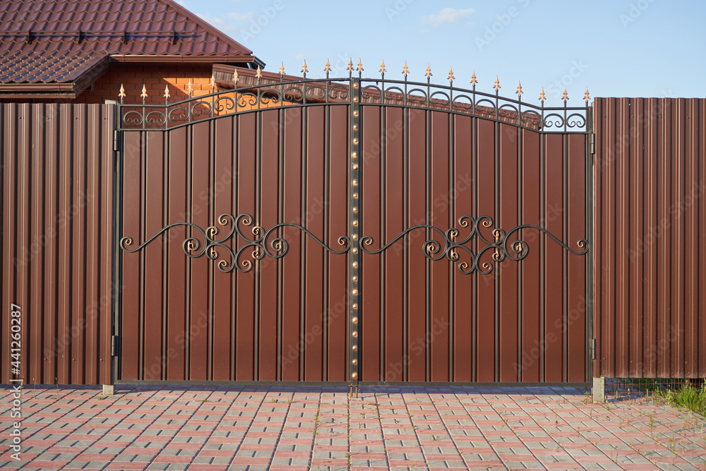 Simple forged gates with metal profile sheet Stock Photo | Adobe Stock