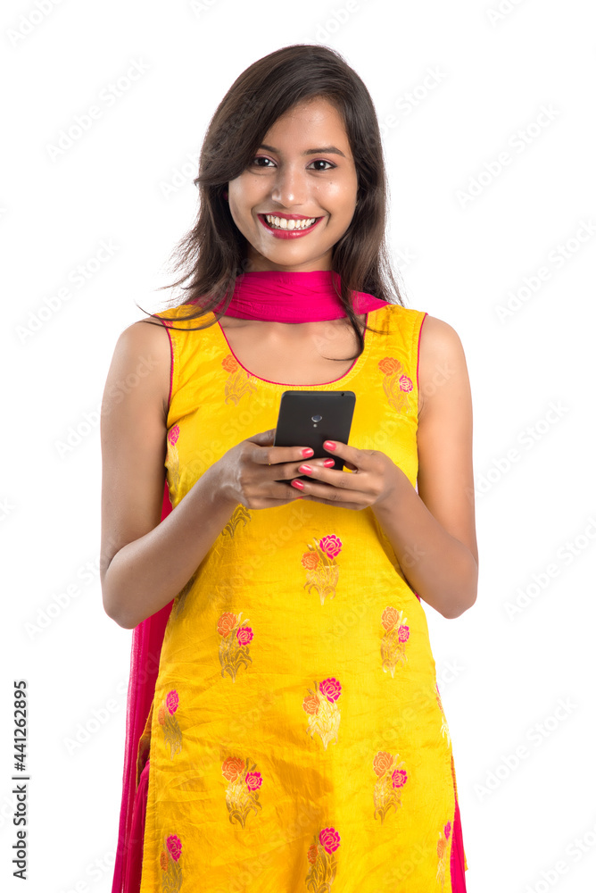 Young Indian girl using a mobile phone or smartphone isolated on a ...