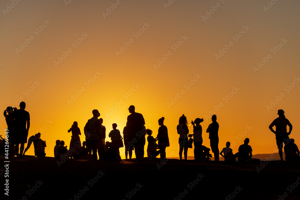 Silhouette of people against yellow sunset. Stock Photo | Adobe Stock