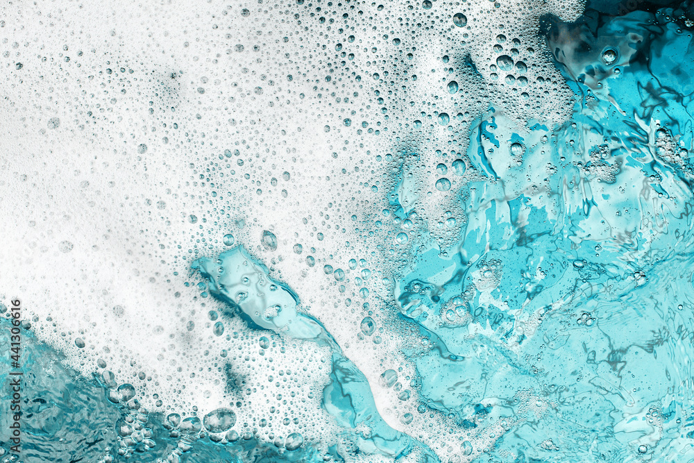 White foam clear blue water background closeup, sea or ocean foam wave ...