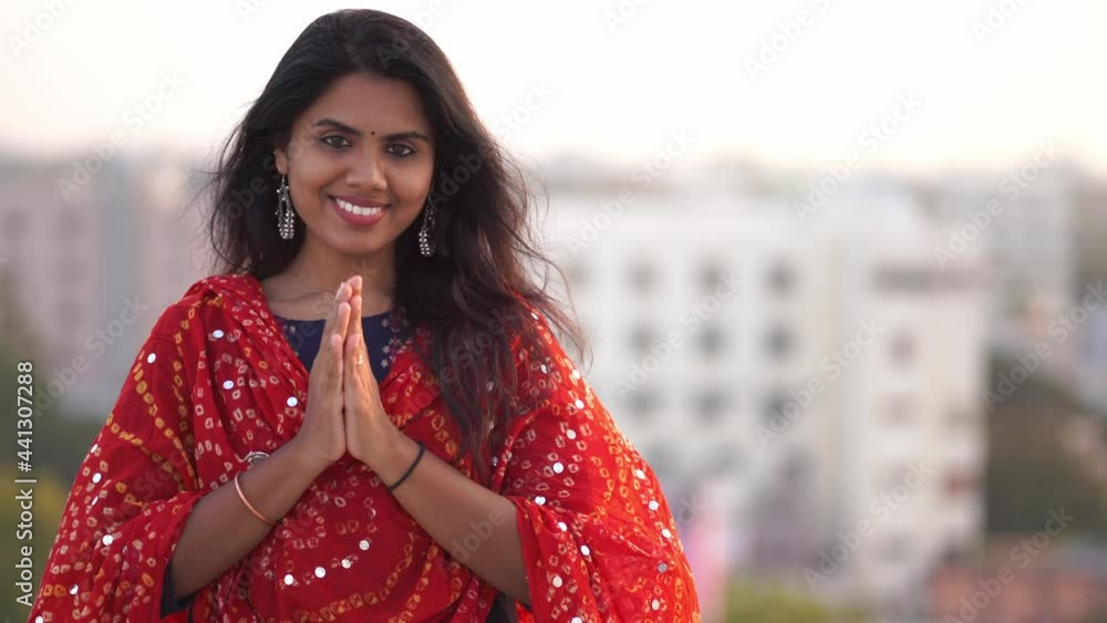 Traditional Indian girl holding hands in prayer position outdoor in 4k ...