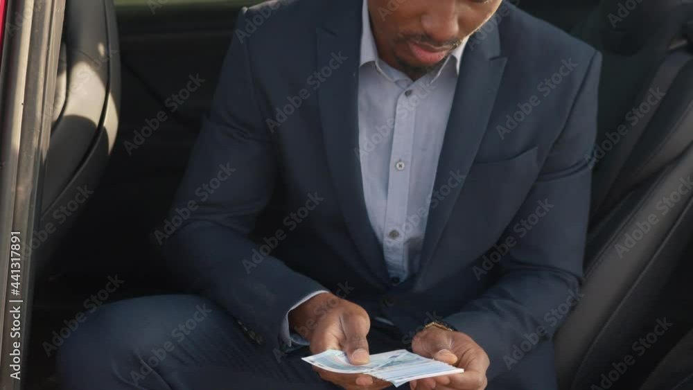 African man counting money. African america man in business suit ...