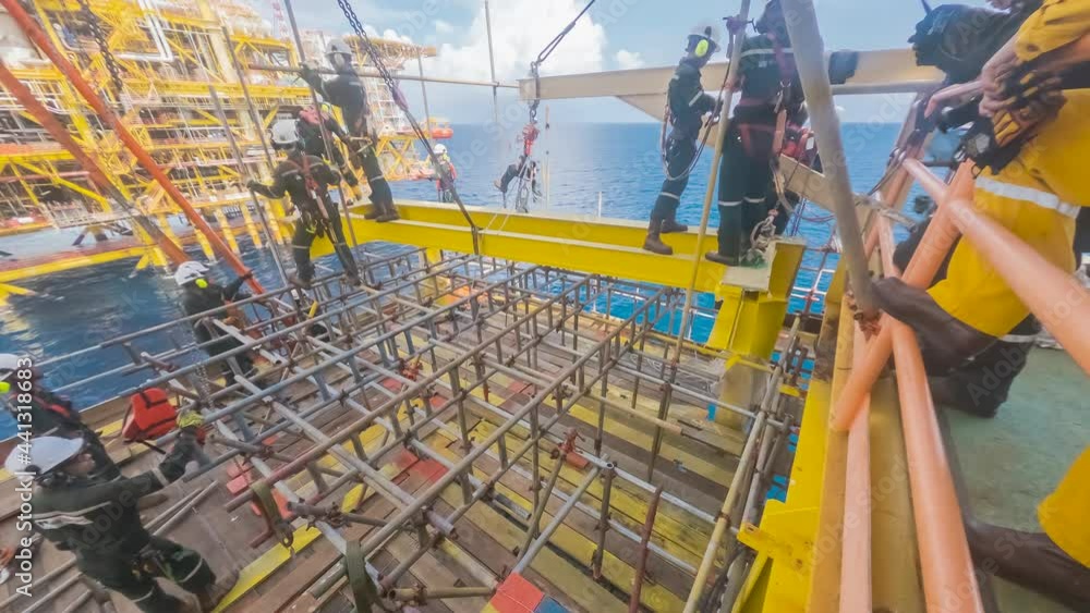 4K time lapse of offshore workers performing heavy lifting works for ...
