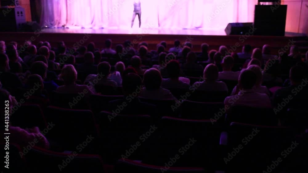 Spectators watch performance show or view in theater, back view ...
