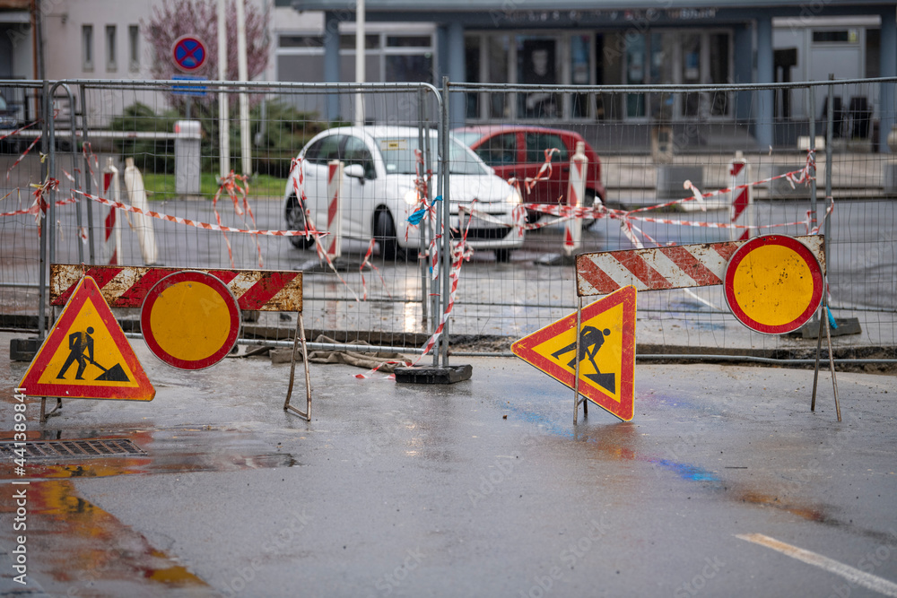 Inner city road closed by signs and boundary around street works ...