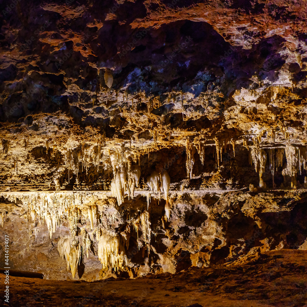 Stalagtite cave with multiple colors and holes in the rock. Stock Photo ...