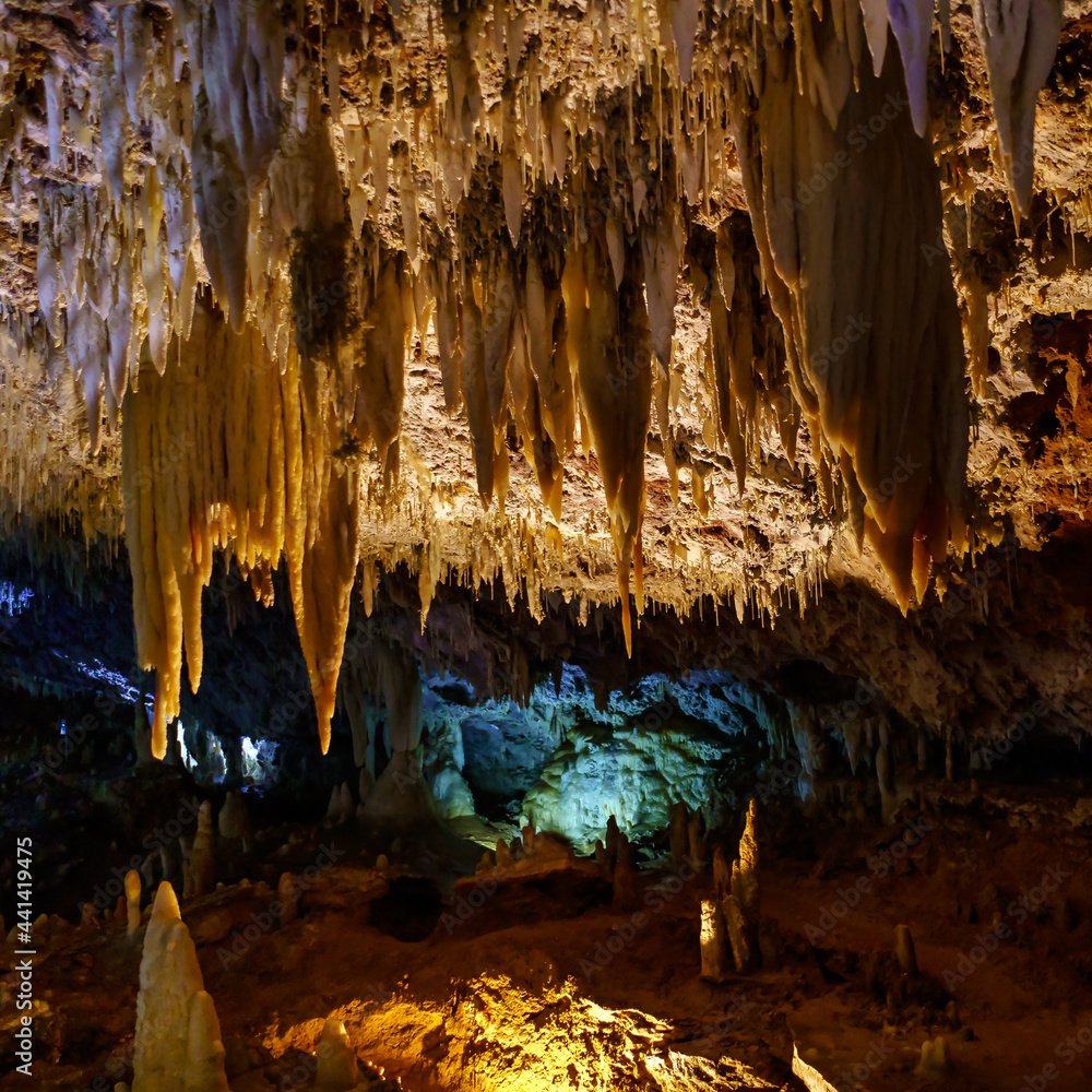 Stalagtite cave with multiple colors and holes in the rock. Stock Photo ...