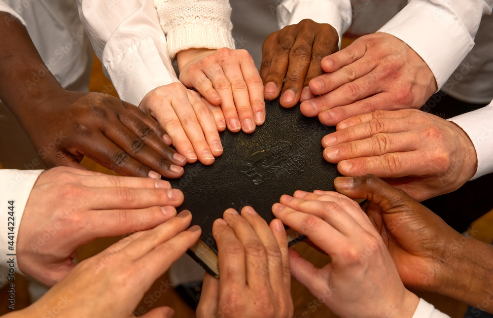 Hands of multiple nationalities, the Body of Christ, black and white ...