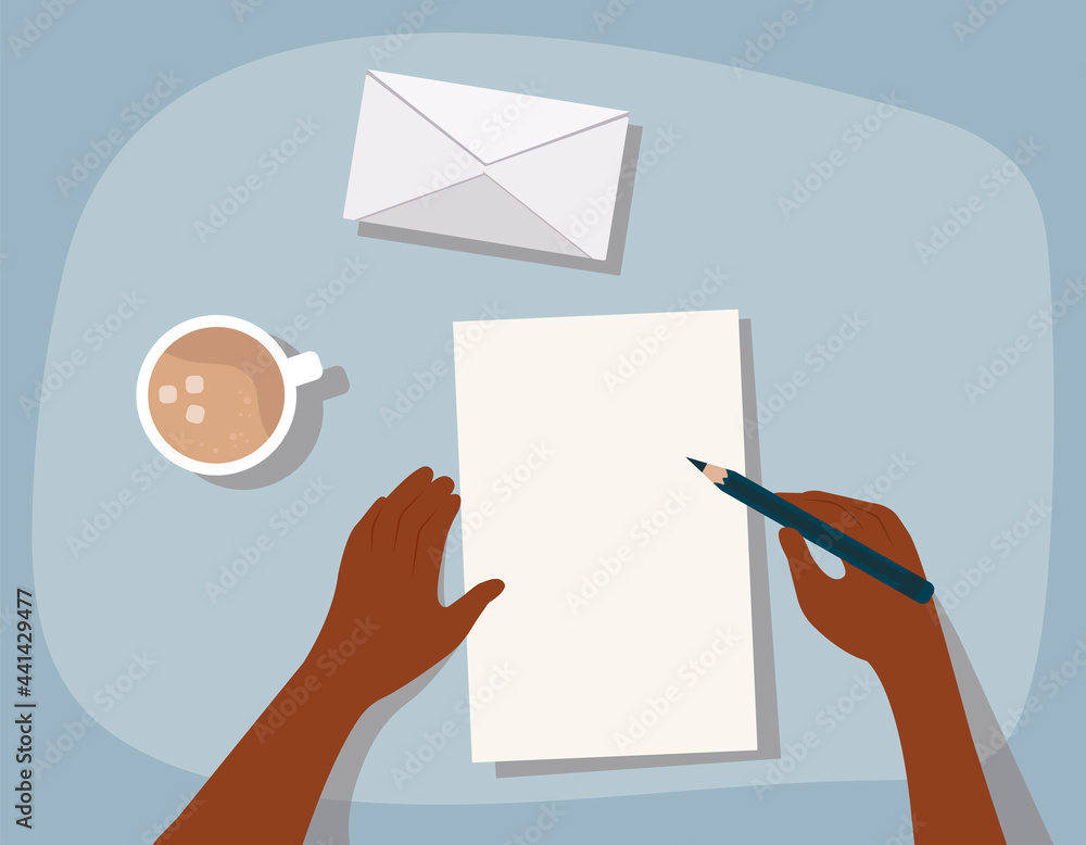 Hands are holding a pencil and writing a letter. Top view of the table ...