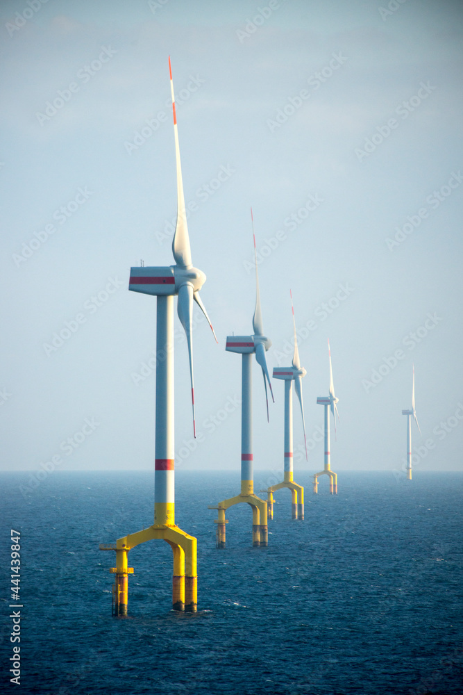Offshore wind farm turbines at dusk in the middle of the sea Stock ...