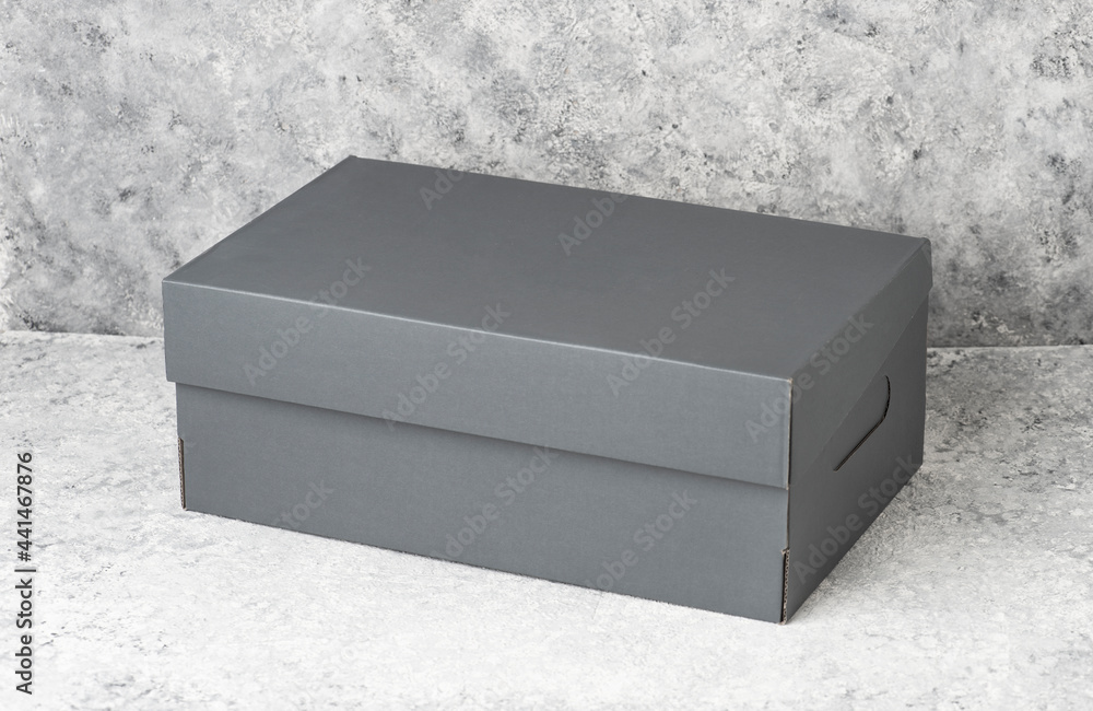Shoebox. Gray color shoebox on gray background. Stock Photo | Adobe Stock