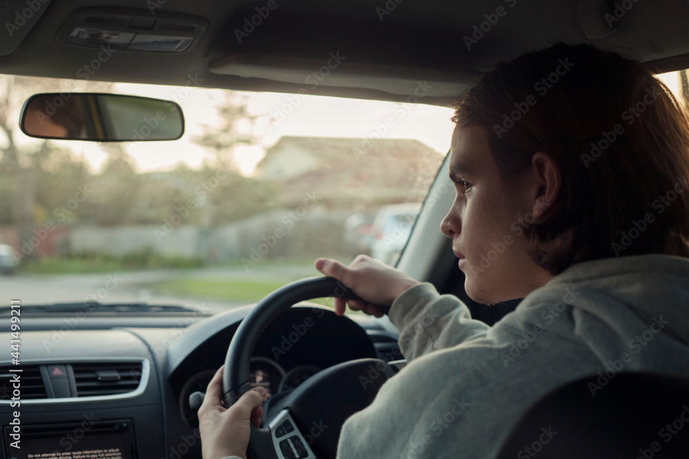 teenage boy driving Stock Photo | Adobe Stock