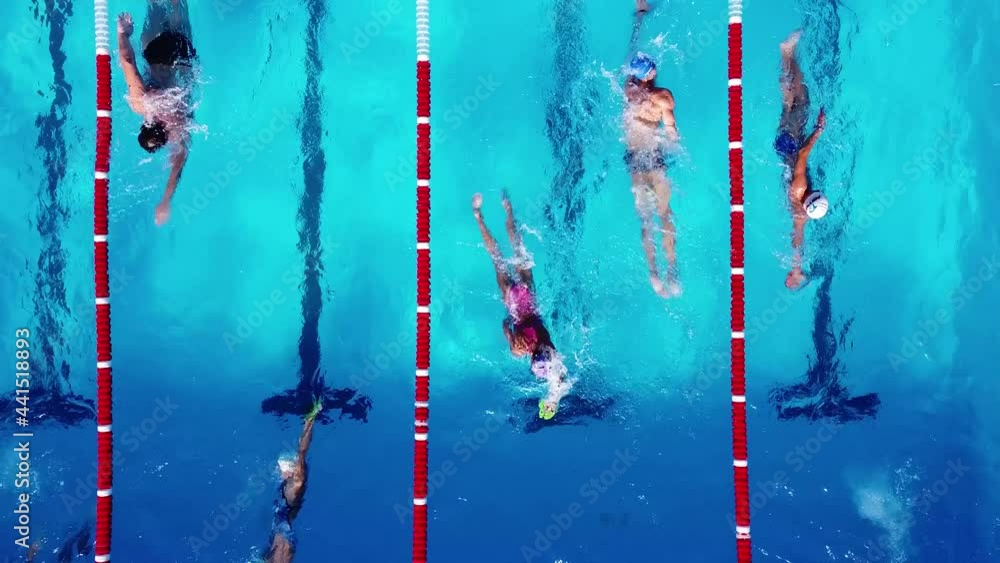 Top view of group of young swimmers training in swimming pool with ...