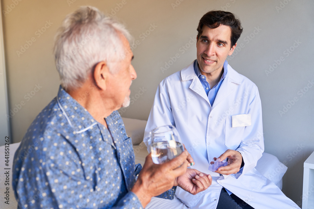 Doctor and senior as patient administering medication Stock Photo ...