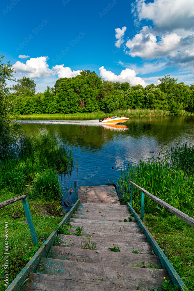Embankment of the Tsna River in Tambov. Boats on Tsna river in Tambov city. Beautiful view on ...