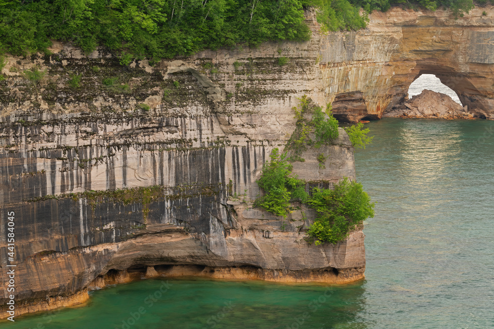 Landscape of the mineral stained, sandstone and eroded shoreline of ...