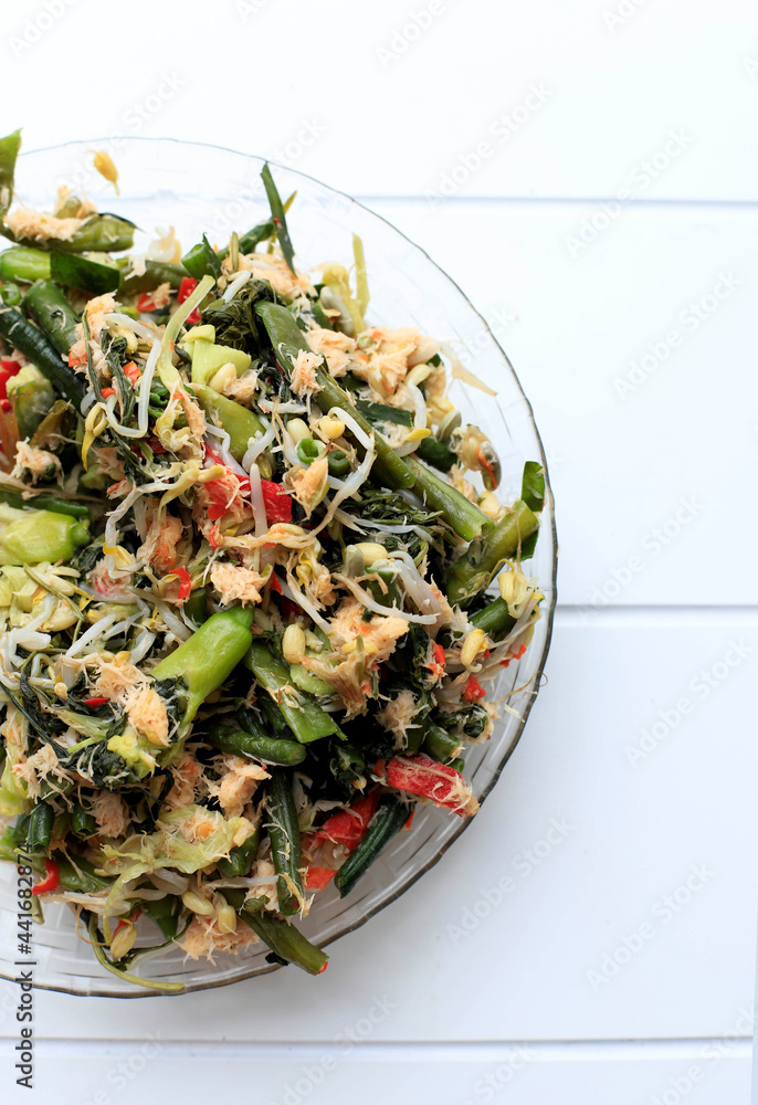 Top View Sayur urap on wood background. Cooked vegetables with spiced ...