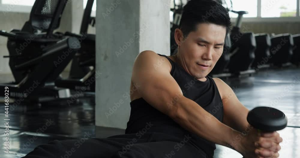 Athletic men exercise focus on specific parts of the body at garage gym ...